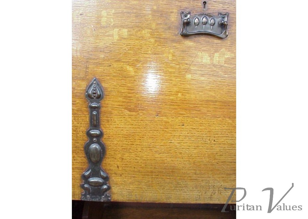 An Arts and Crafts oak fall front bureau with copper handles and hinges ...