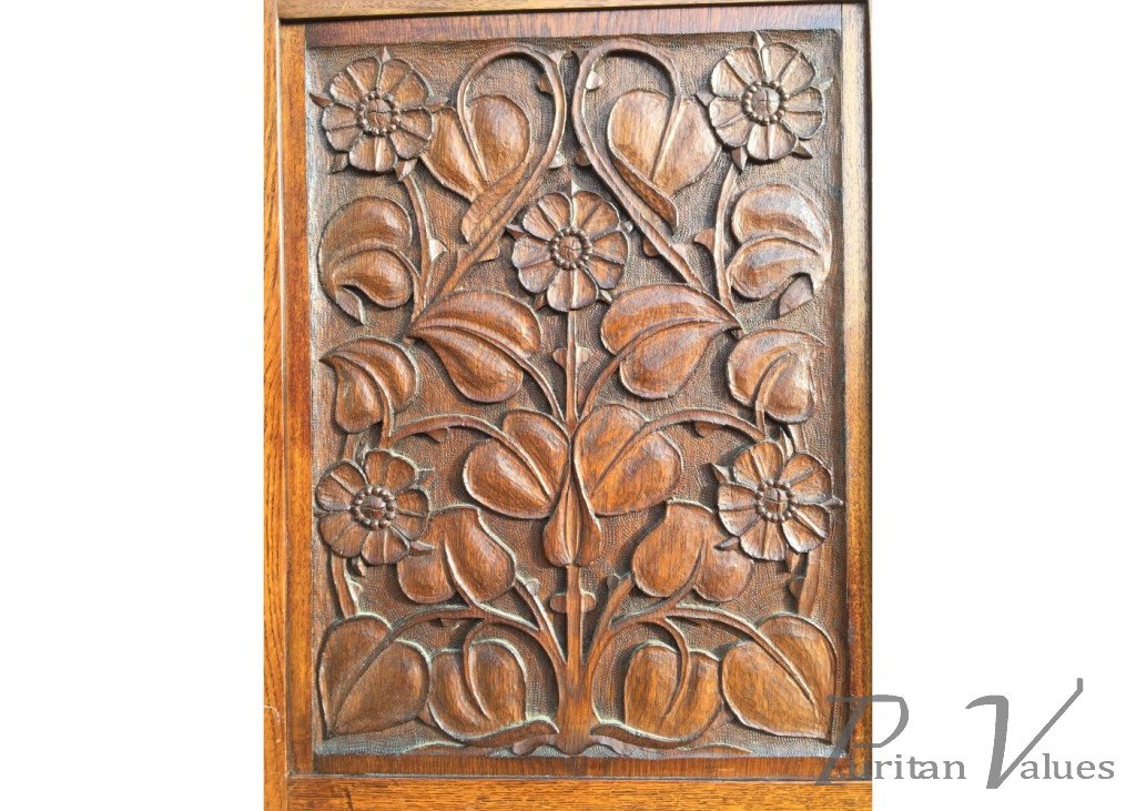 Arthur Simpson. An Arts Crafts mirror with shaped top, the central ...