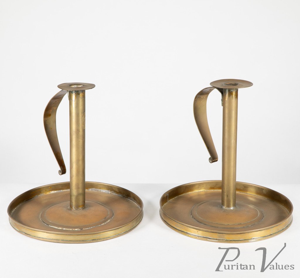 A pair of Scottish School Arts & Crafts brass candlesticks w circular ...