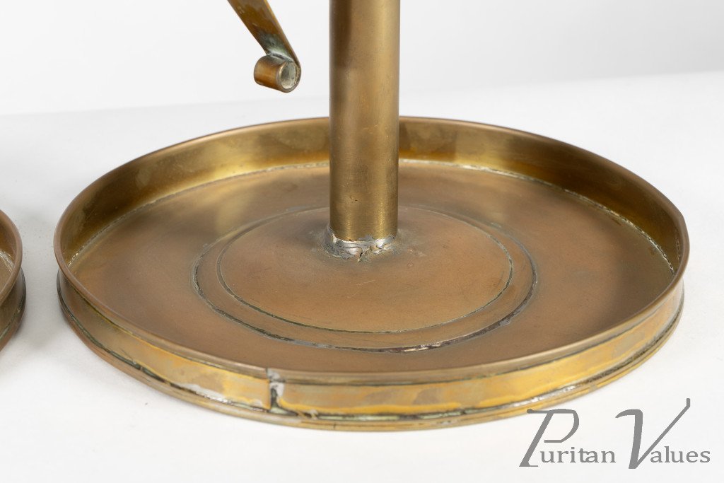 A pair of Scottish School Arts & Crafts brass candlesticks w circular ...