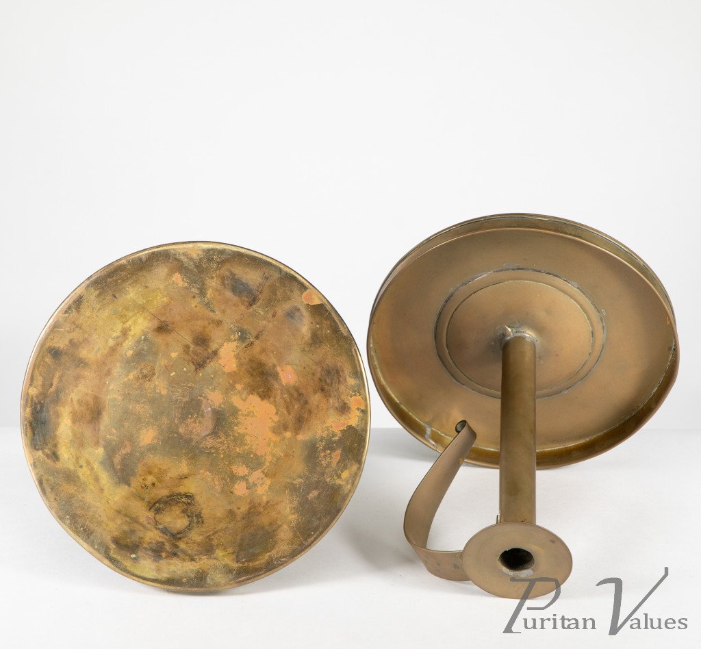 A pair of Scottish School Arts & Crafts brass candlesticks w circular ...