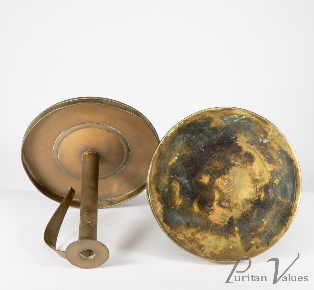 A pair of Scottish School Arts & Crafts brass candlesticks w circular ...