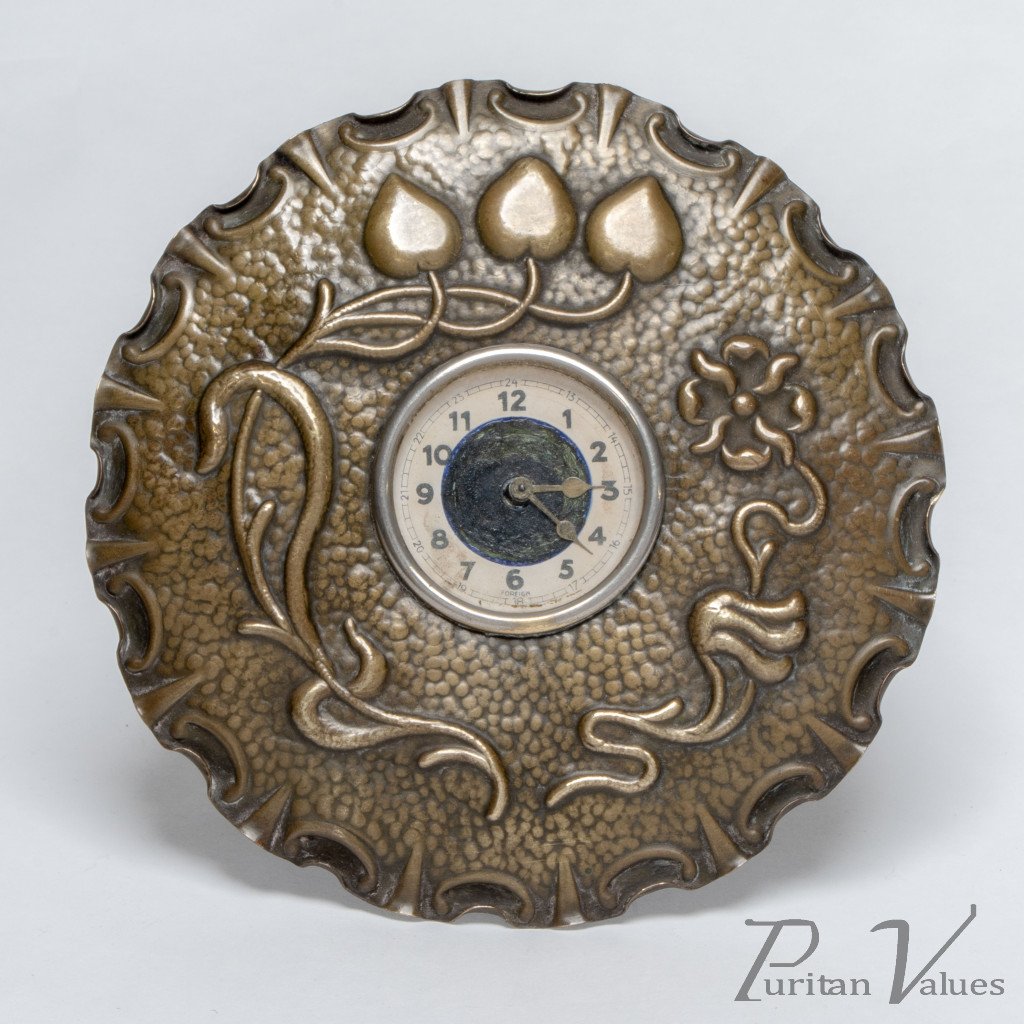 A little Arts & Crafts copper table clock in the shape of a flower head ...