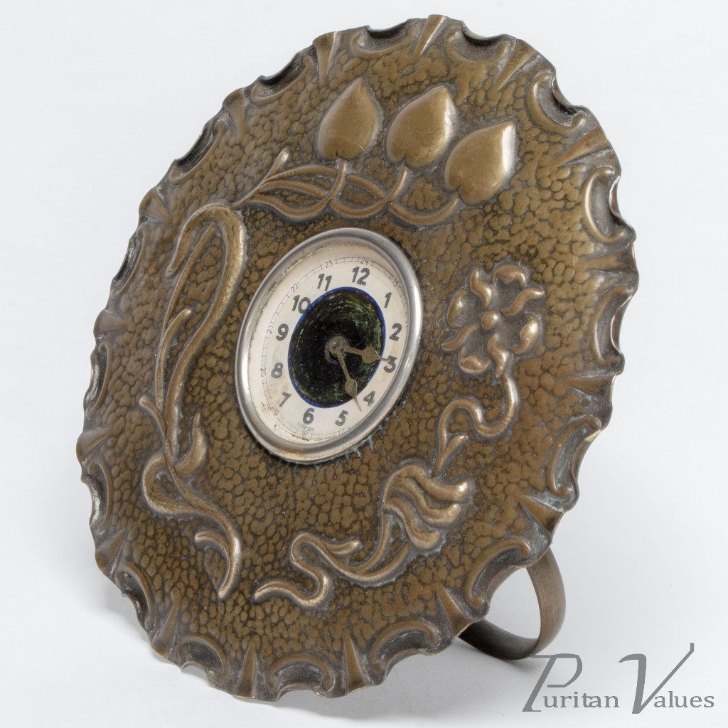 A little Arts & Crafts copper table clock in the shape of a flower head ...