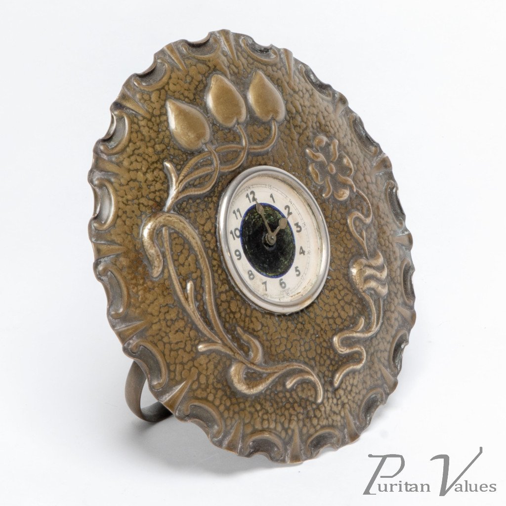 A little Arts & Crafts copper table clock in the shape of a flower head ...