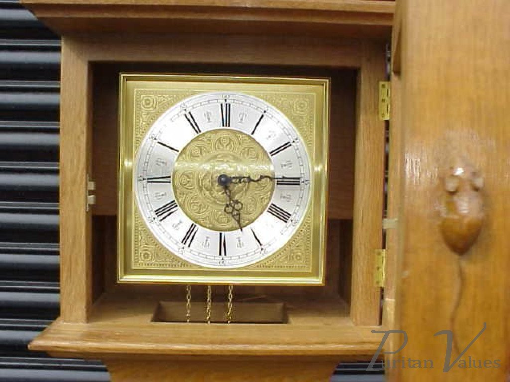 Robert Mouseman Thompson. A rare oak longcase clock - Puritan Values